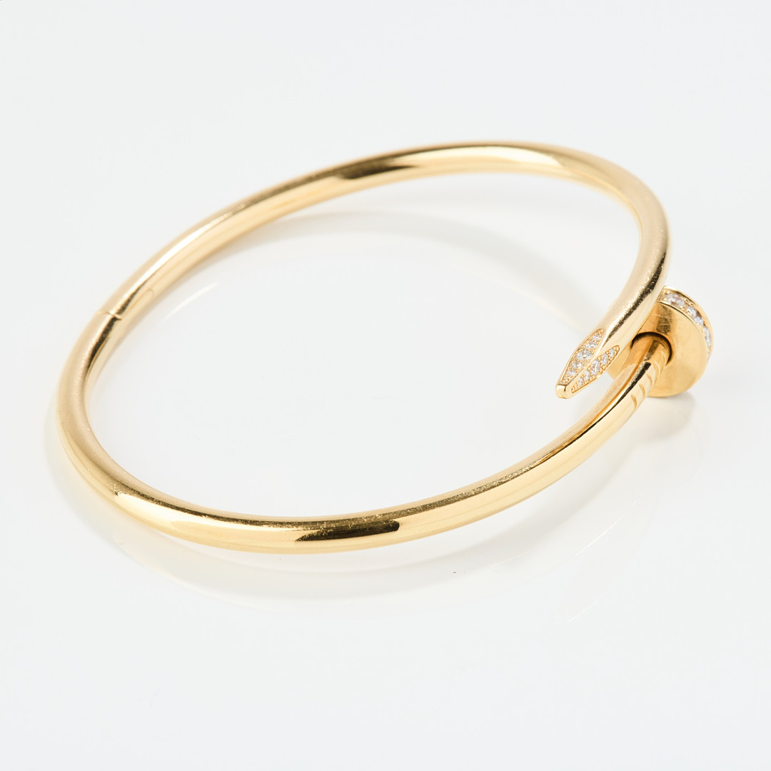CARTIER. Bangle, “Juste un Clou”, classic model, 18K gold with diamonds ...