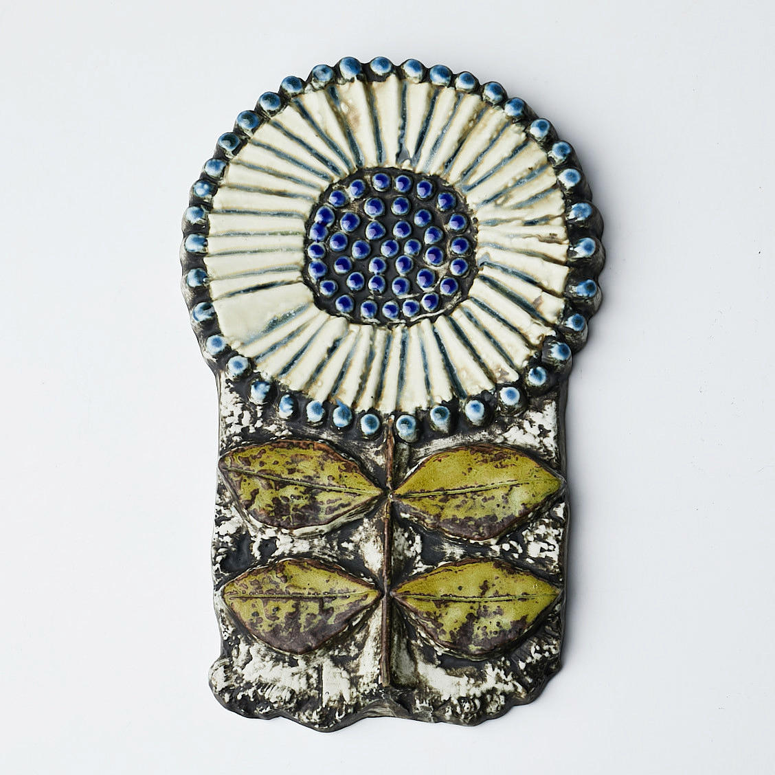 LISA LARSON. Wall plaque, with sunflower motif, glazed stoneware ...