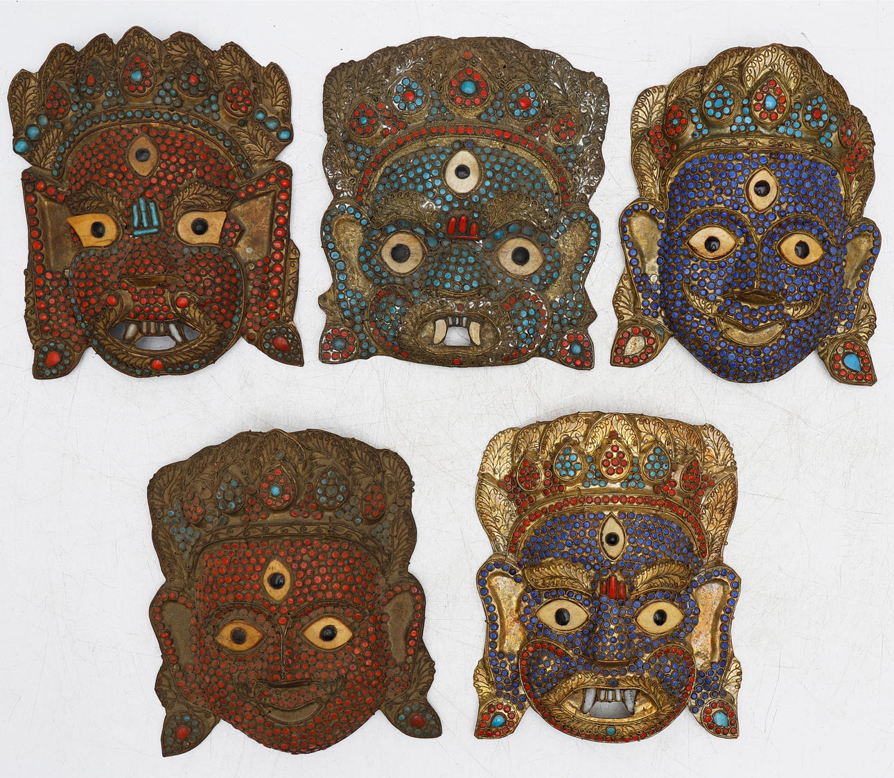 Set of five Nepalese masks in brass with bone inlays, imitation ...