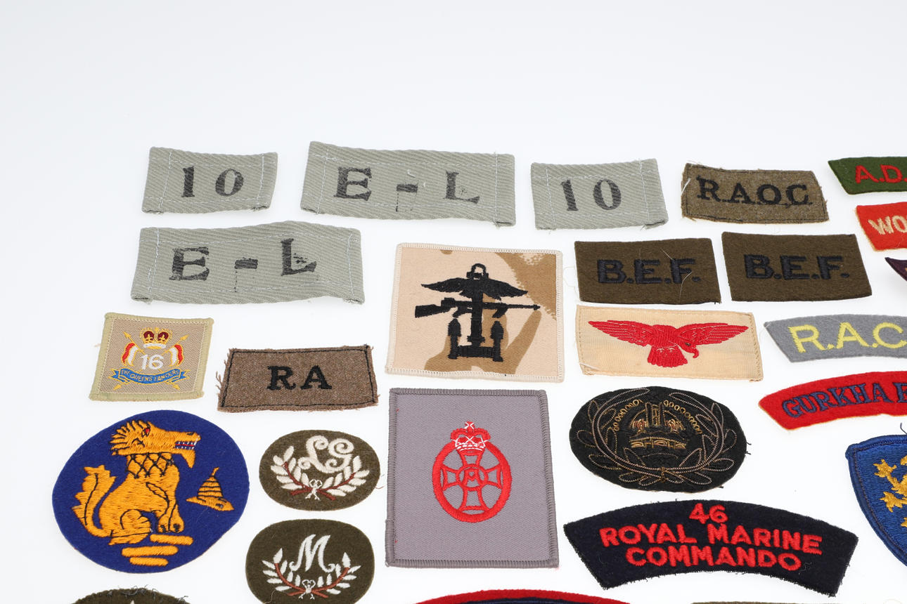 A LARGE COLLECTION OF MILITARY UNIFORM CLOTH PATCHES, SHOULDER TITLES ...