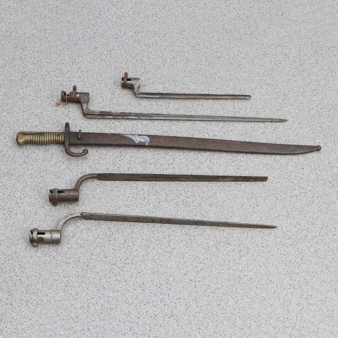 BAYONETS, FIVE PCS. Metal. Four socket bayonets and 1 saber bayonet ...