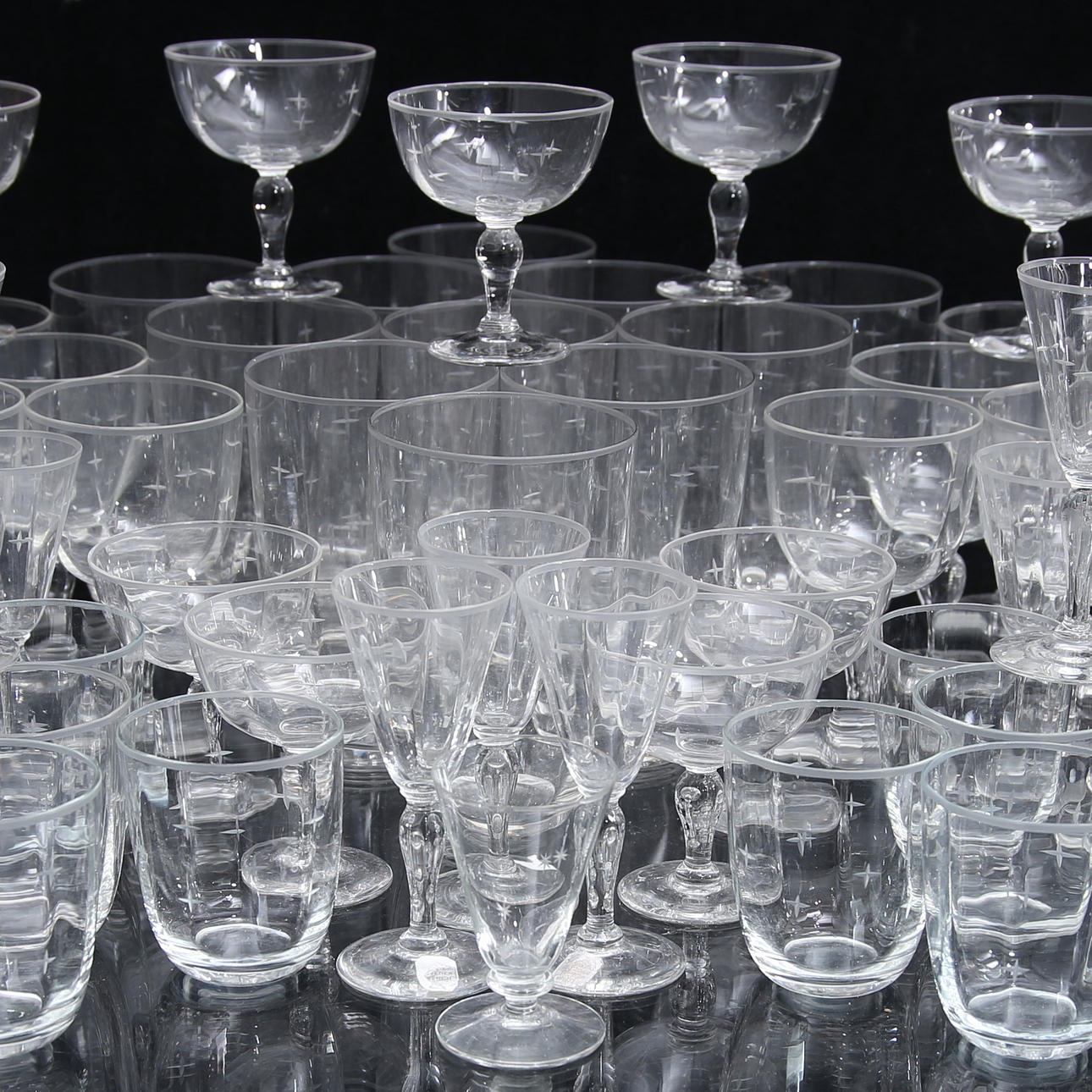 ELIS BERGH. A 54-piece glass tableware set with cut stars, Kosta, 20th ...