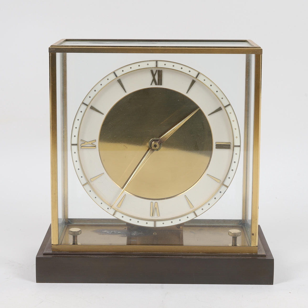 A 20th century battery-operated metal/glass table clock. Clocks ...