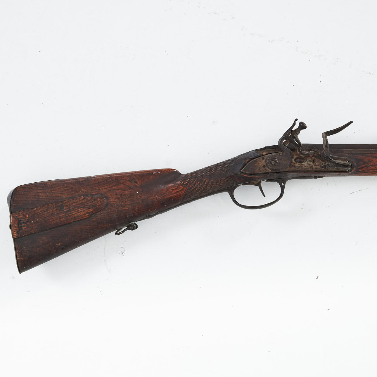 A 18th-century flintlock rifle, octagonal smooth-bore barrel, iron ...