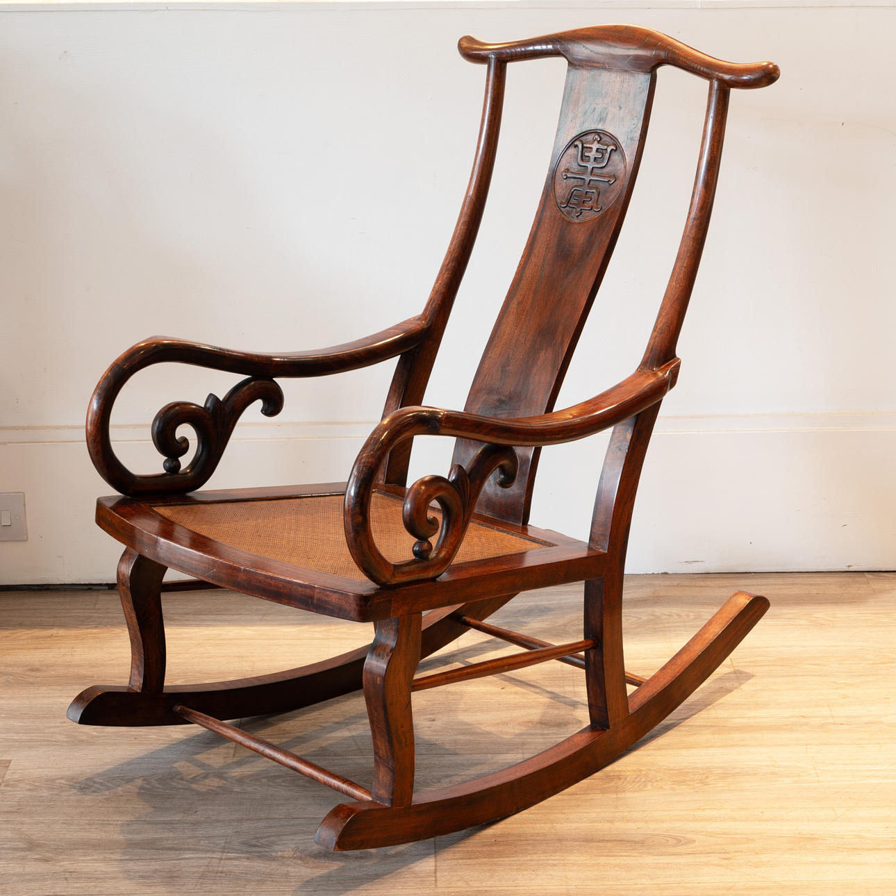 A CHINESE HARDWOOD AND RATTAN SEAT RECLINING YOKE-BACK ROCKING CHAIR ...