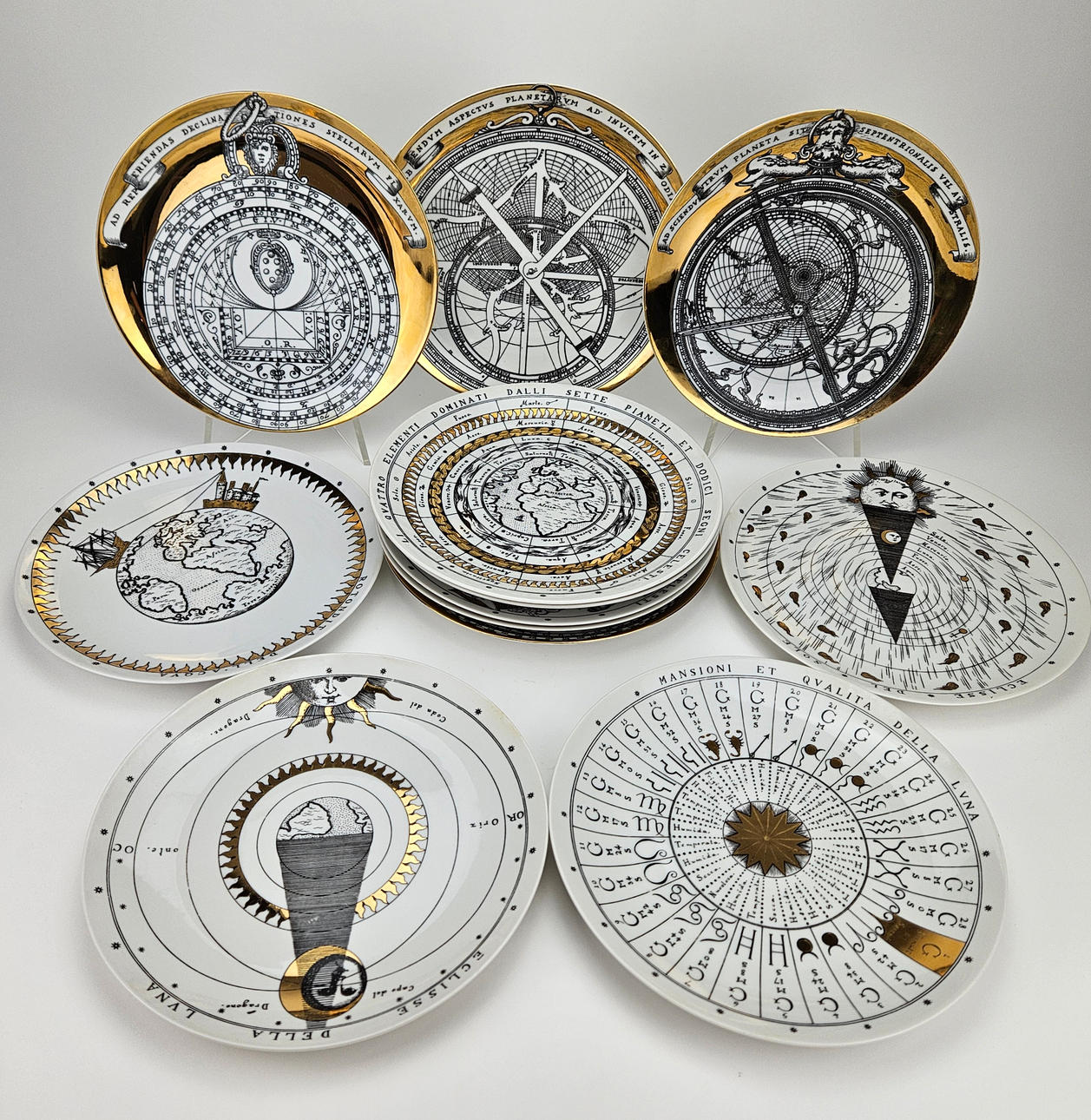 PIERO FORNASETTI. A set of 12 'Astronomici' and 'Astrolabio' porcelain ...