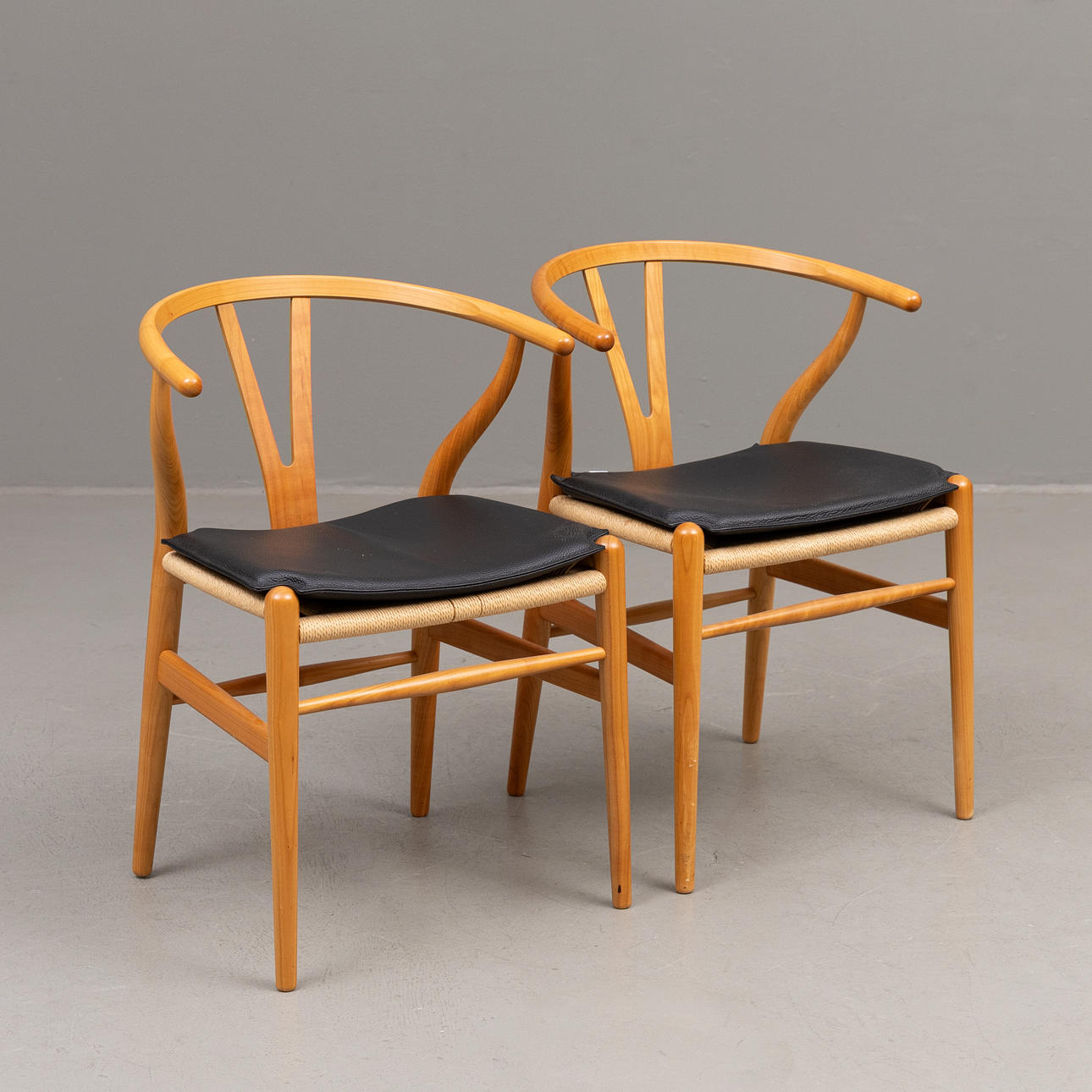 HANS J WEGNER. Two “Y-chair” /CH 24" armchairs, cherry, 62/125 and 63/ ...