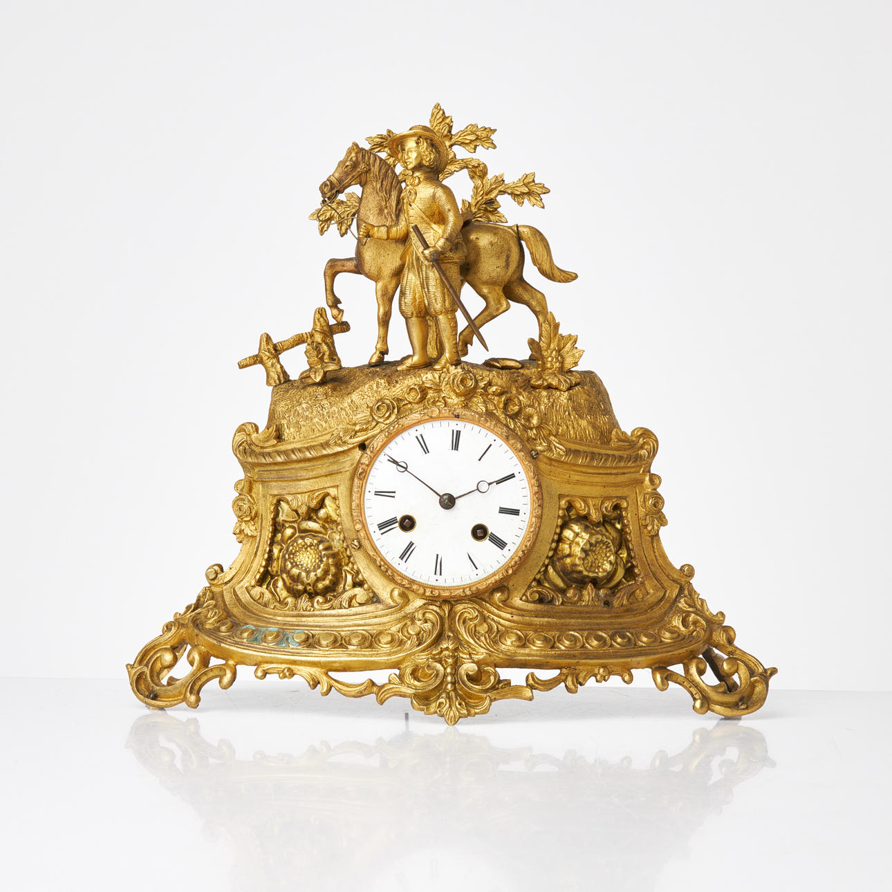 A patinated metal table clock, 1800/20th century, crowned by a man with ...