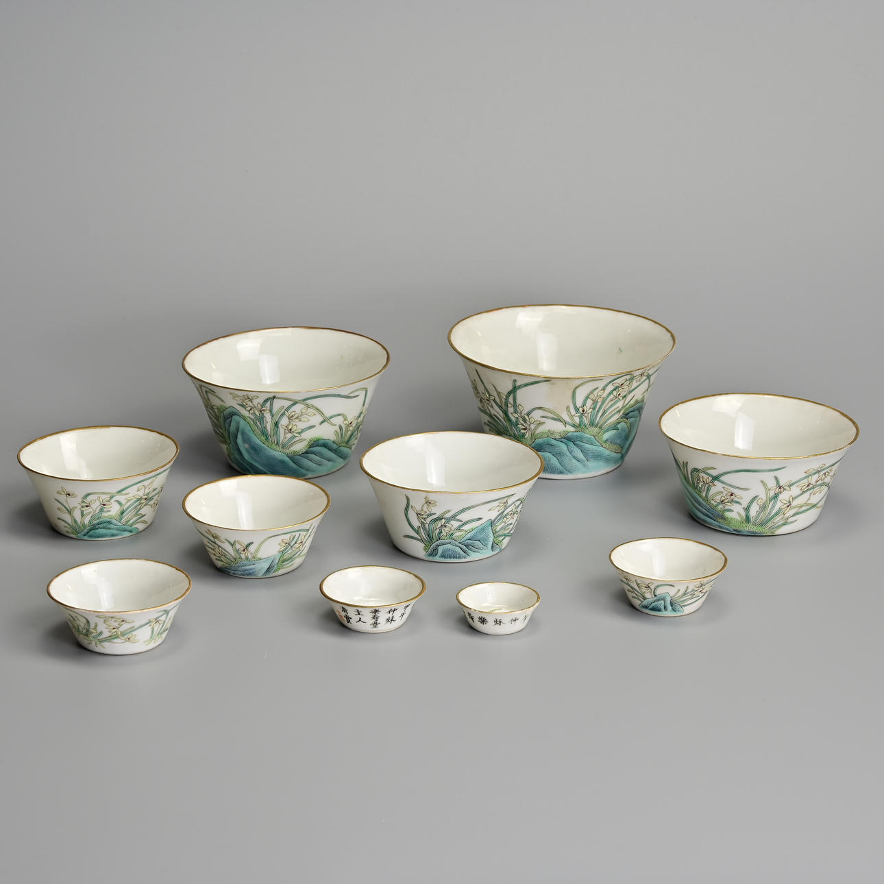 A SET OF TEN CHINESE FAMILLE VERTE GRADUATED PORCELAIN WINE CUPS ...