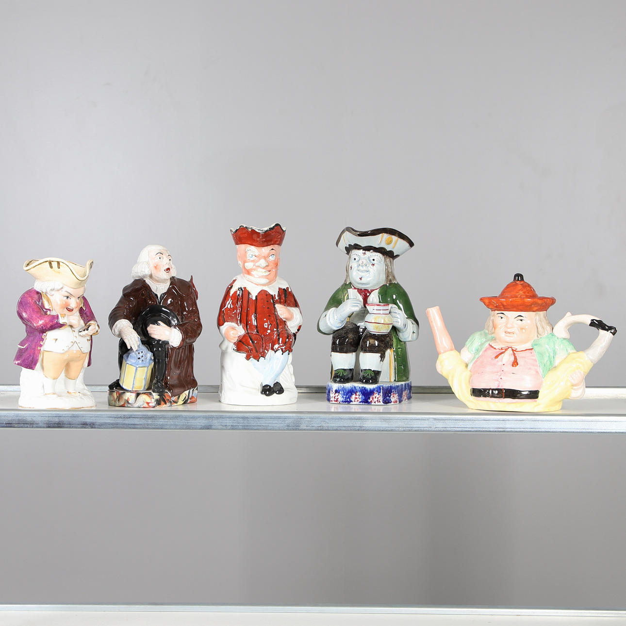 A GROUP OF FOUR 19TH CENTURY AND LATER STAFFORDSHIRE TOBY JUGS ...
