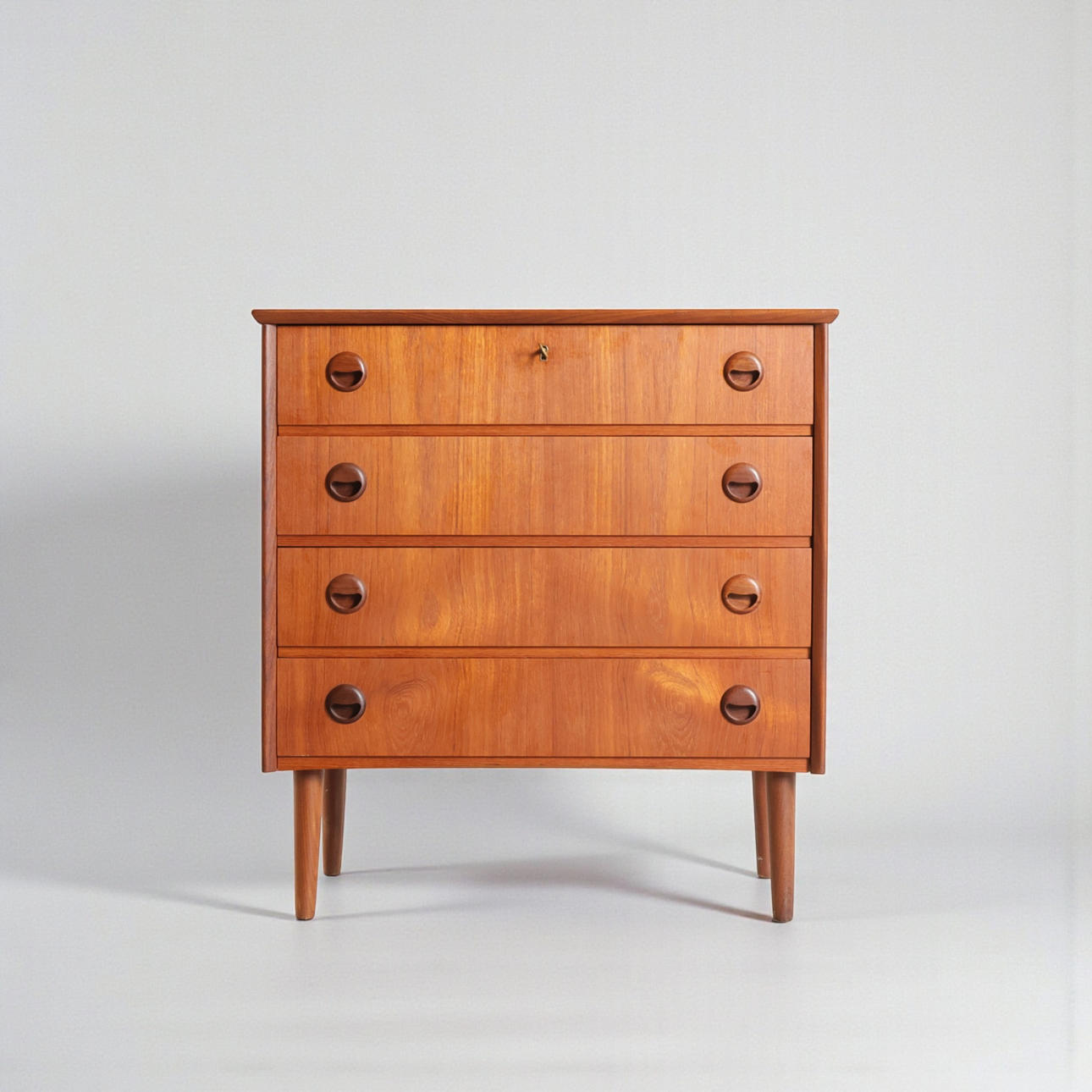 Teak chest of drawers, front with four drawers with round handles ...