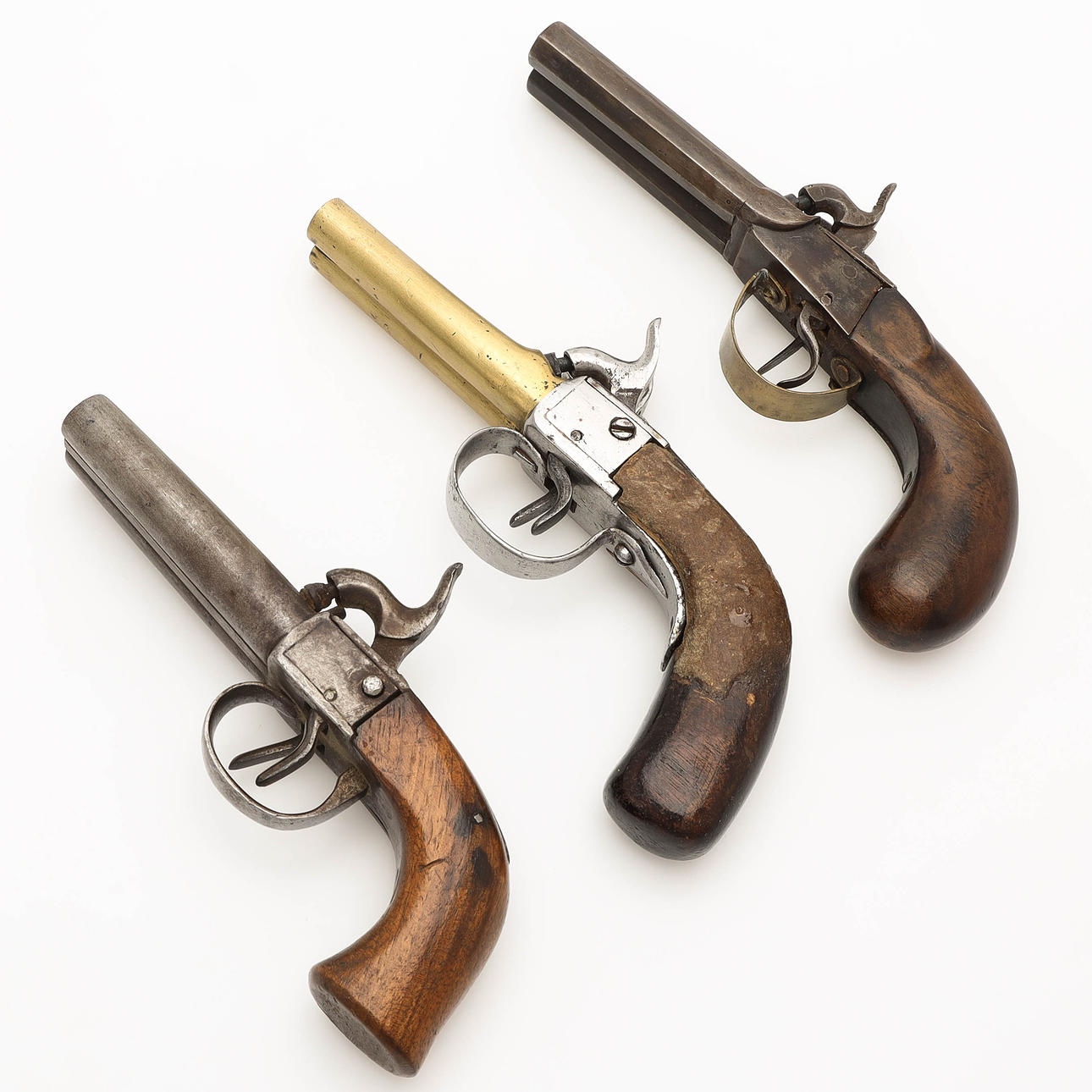 A set of three double-barrelled lock pistols, 19th century. Weapons ...