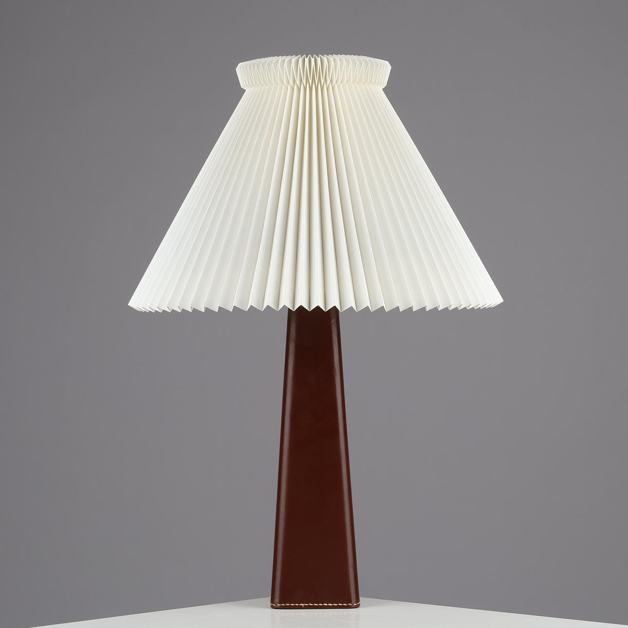 Conical table lamp covered with brown leather, presumably made for ...