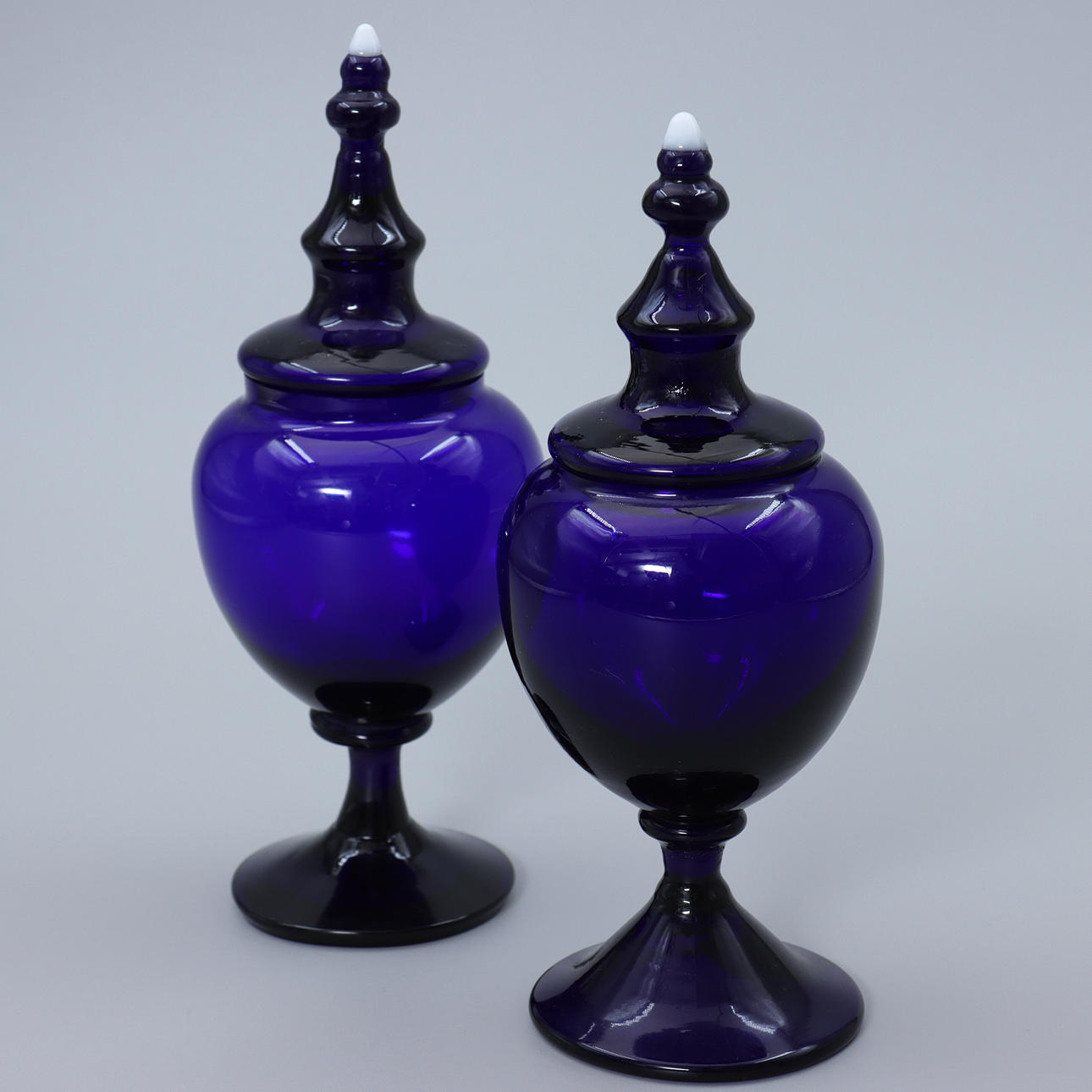 POTPOURRI URNS, BLUE GLASS WITH WHITE KNOB, THE PAIR ARE SIMILAR ...