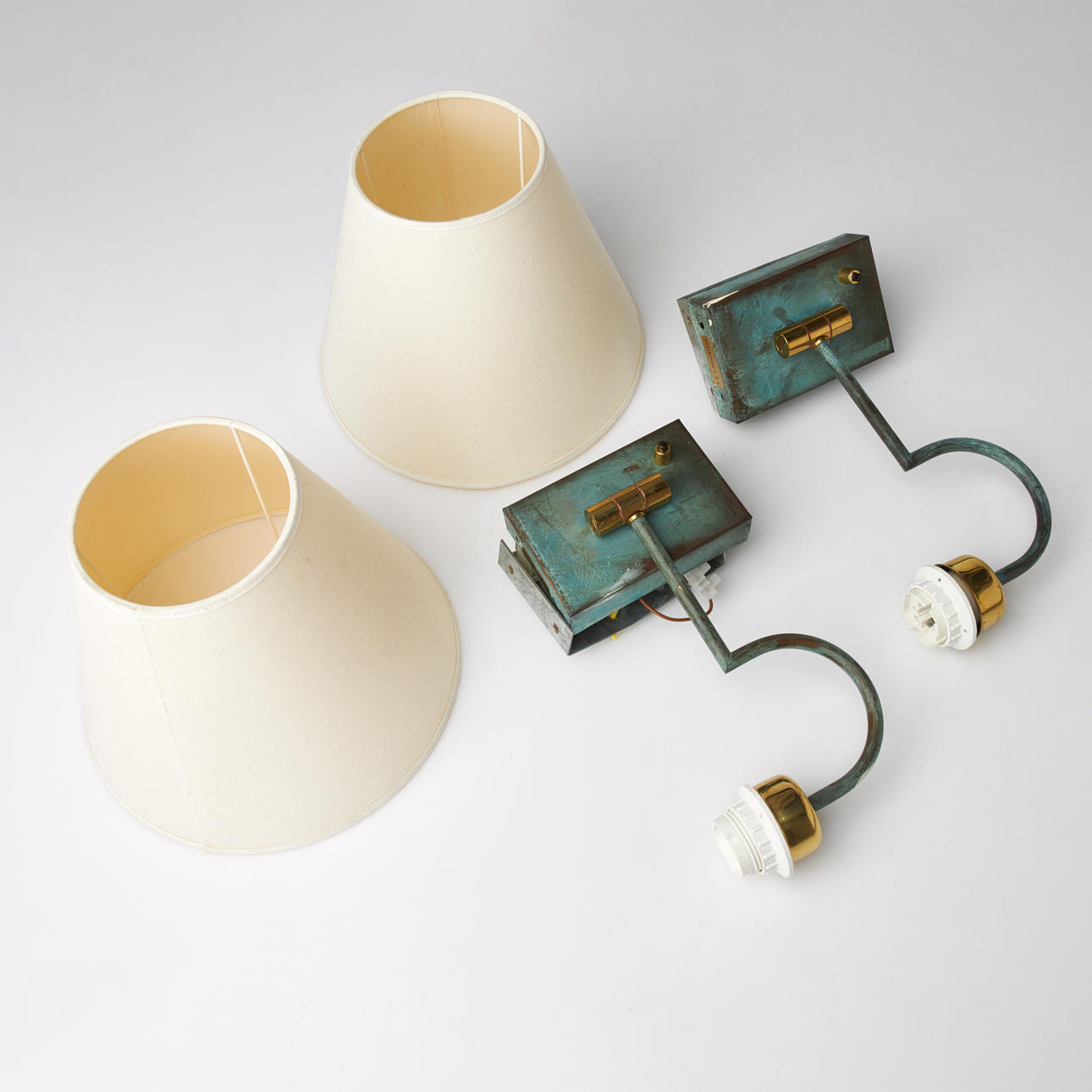 WALL LAMPS. 1 pair, R&S Robertson, patinated metal, yellow metal ...