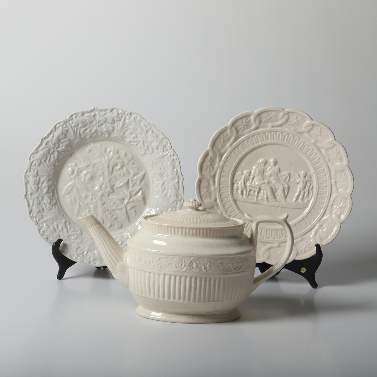 A set of 11 glazed ceramic plates and teapots, Höganäs, early 20th ...