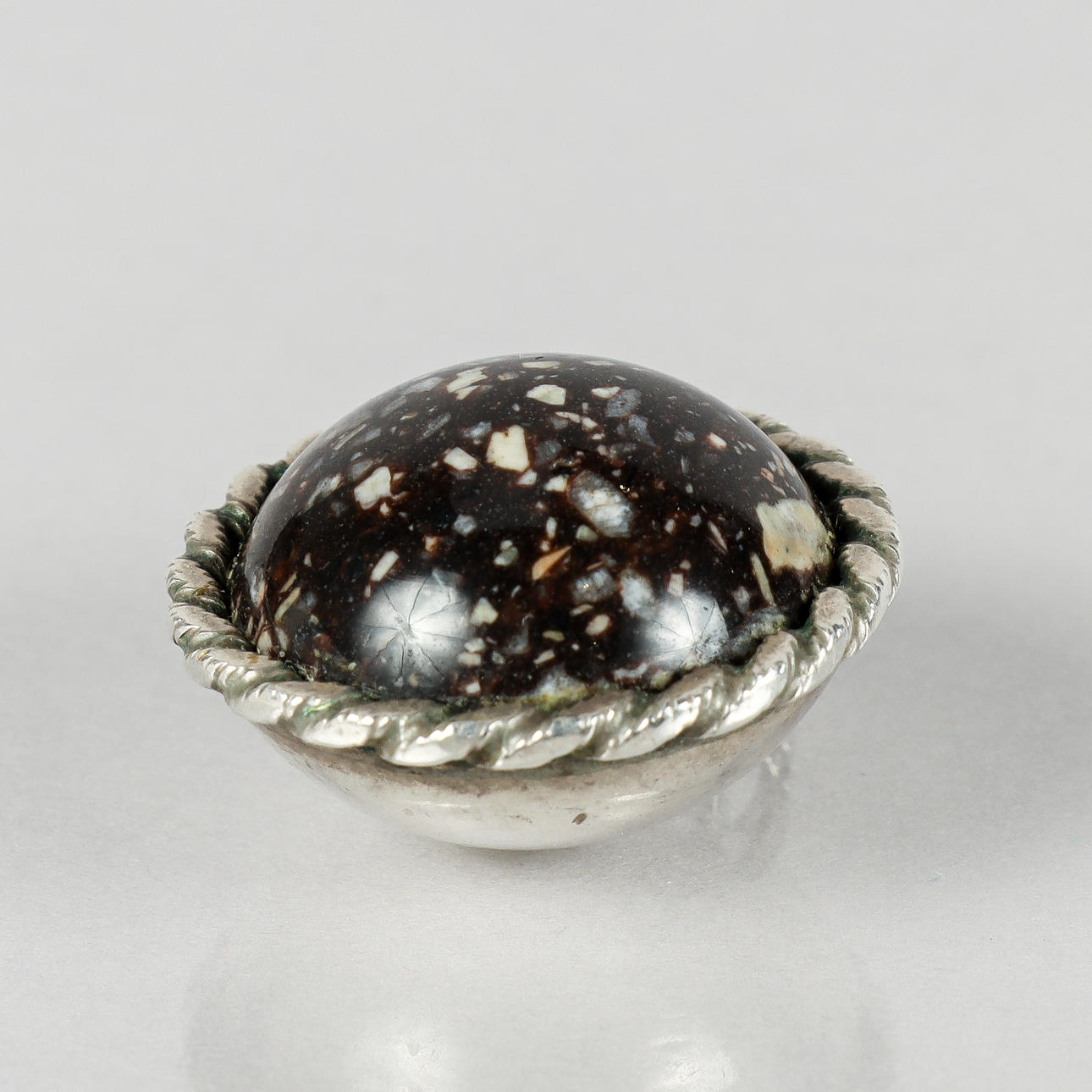 A PENDANT, silver with cabochon-cut porphyry, indistinct stamp ...