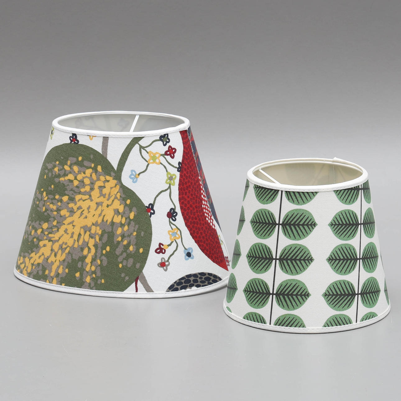 A set of two lampshades, one dressed in “Berså” design Stig Lindberg ...