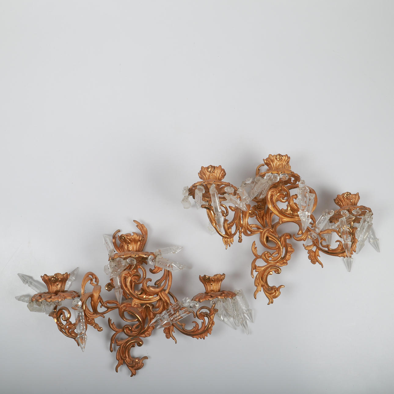 A pair of rococo wall sconces, gilded with prisms, 20th century ...