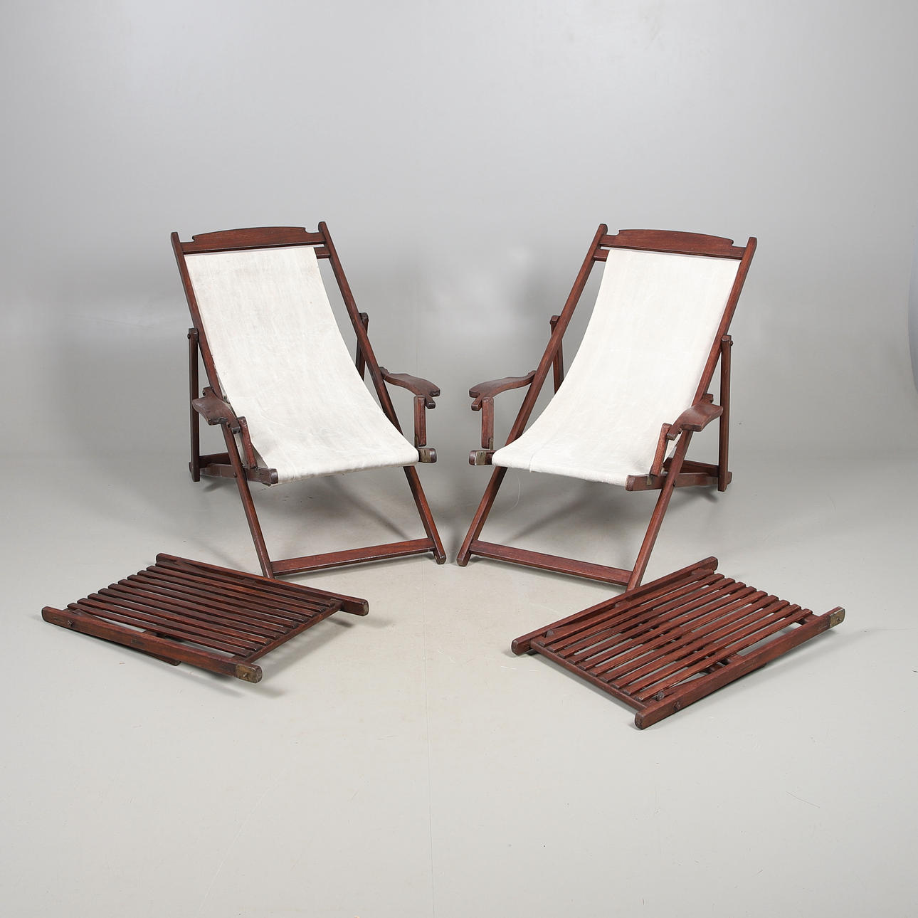 PAIR OF EDWARDIAN CANVAS DECK CHAIRS WITH DETACHABLE FOOT STOOLS ...