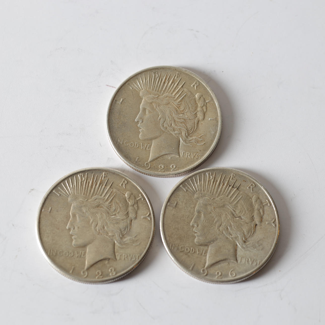 A set of three US silver Peace Dollars coins, 20th century. Total ...