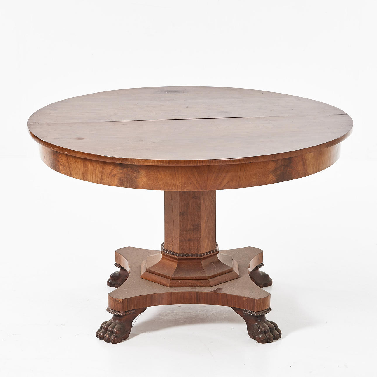 A mid 19th century late empire dining table, mahogany veneer, paw ...