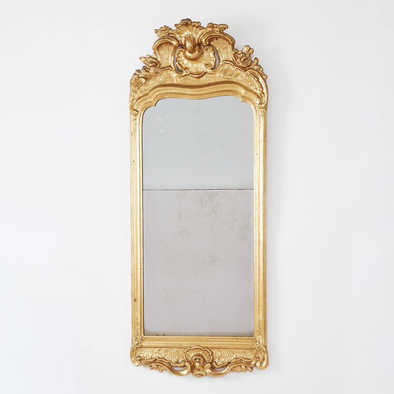 A 17th-century rococo mirror, gilt, carved in wood and decorated in ...