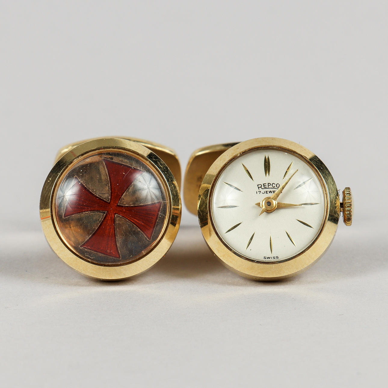 CUFFLINKS a pair, 18k gold, one with glazed order cross and one with ...
