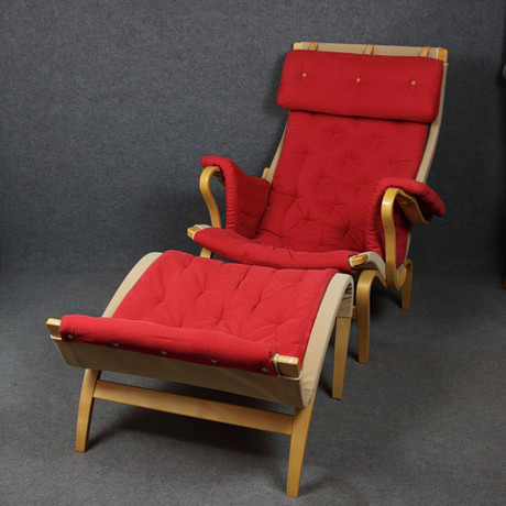 BRUNO MATHSSON. Armchair with footstool, "Pernilla", raspberry red ...