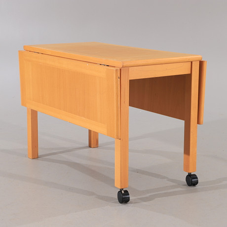 TABLE WITH FLAPS AND WHEELS, 2000s. Furniture - Tables - Auctionet