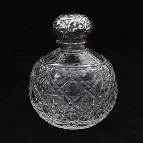 AN EDWARDIAN SILVER MOUNTED SPHERICAL CUT GLASS TOILET WATER BOTTLE ...