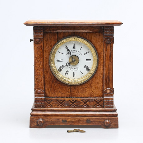 TABLE CLOCK, stained oak, marked "Fattorini & Sons, Bradford", England ...
