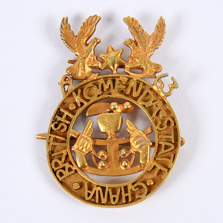 A GOLD CAP BADGE PRESENTED BY THE PRESIDENT OF GHANA TO LT COMMANDER ...