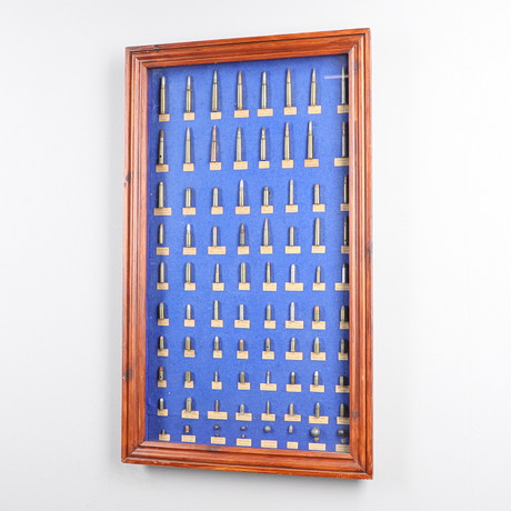 A DISPLAY CASE CONTAINING A COLLECTION OF BULLETS OF VARIOUS TYPES ...