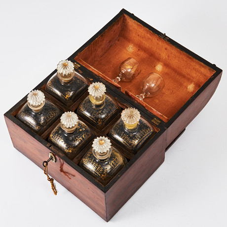 BOTTLE CHEST, 19th century, veneered in walnut and mahogany, 6 bottles ...