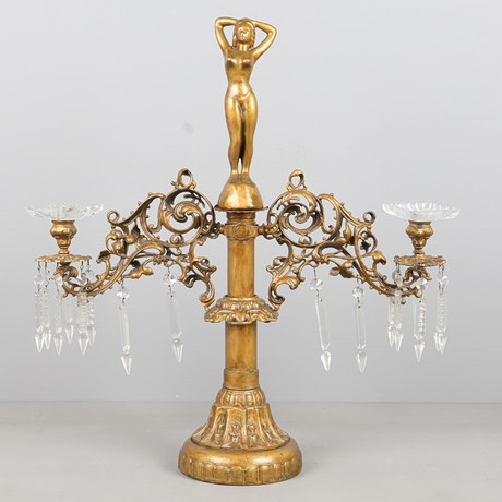 CANDELABER, bronzed metal frame, draped with prisms, crowning female ...