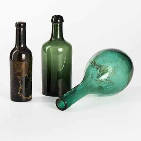 BOTTLES, 3 pieces, 19th century, green tinted glass mass. Glass ...