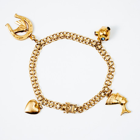 ARMBAND, 18 k guld, x-länk, med berlocker, bl a föreställande hästsko ...