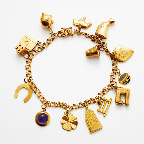 BRACELET, 18k gold, Bismarck link with charms, i.a. representing sewing ...