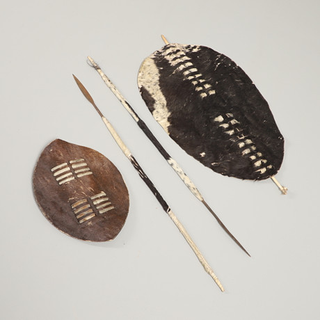 TWO ZULU TYPE COWHIDE SHIELDS AND SIMILAR SPEARS. Weapons & Militaria ...