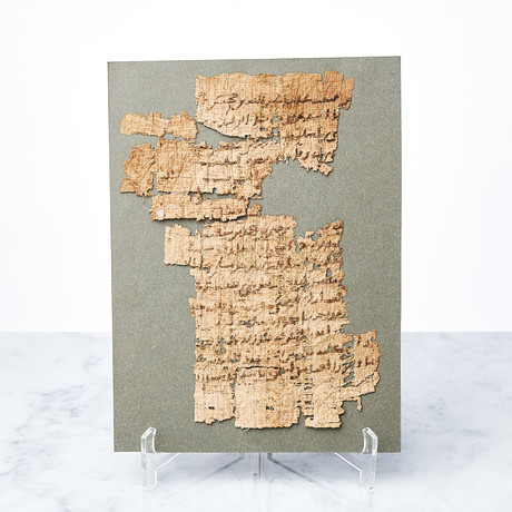 PAPYRUS FRAGMENT, 7th/8th century, Arabic, lies loosely between 2 glass ...