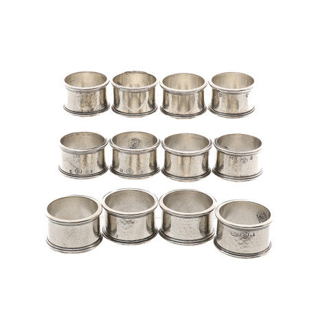 MARINONI. A SET OF TWELVE PEWTER SPOT-HAMMERED NAPKIN RINGS. Silver ...