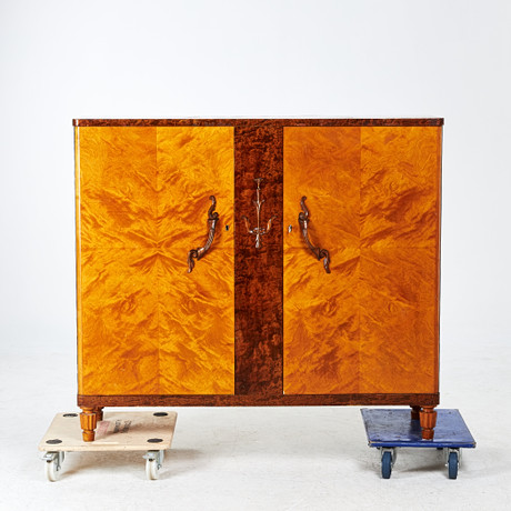 CABINET. 1940s, pull handles cut in wood, veneered with flame birch and ...