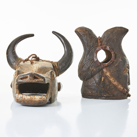 Two 20th-century woodcut masks, partly pigmented with kaolin, one of ...