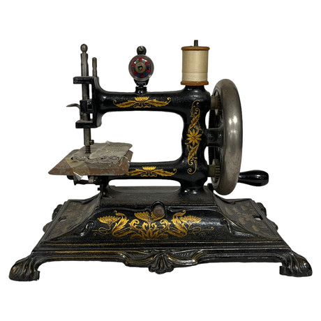 A small sewing machine, the first staple of the 20th century ...