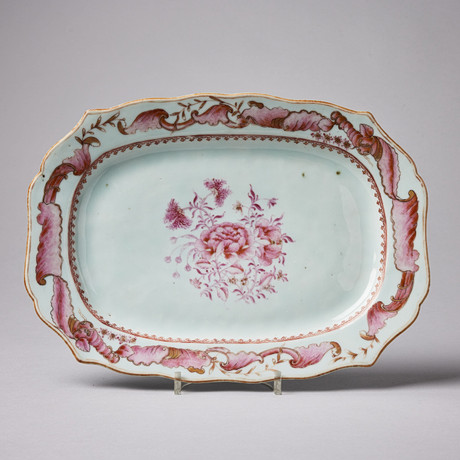 A FAMILLE ROSE DISH, of oval form with barbed rim with a band of pink ...