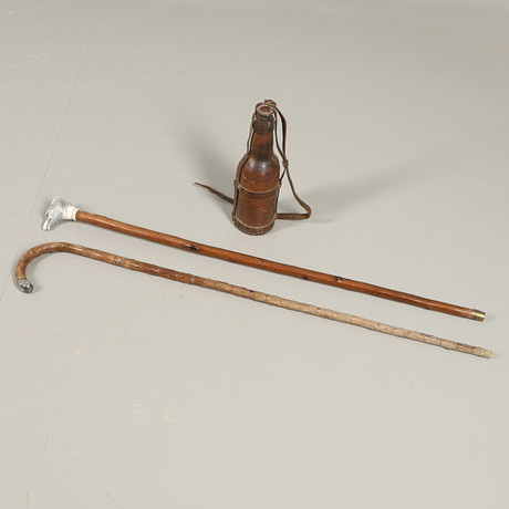 A SILVER TOPPED WALKING CANE, ANOTHER WALKING CANE AND A DRINKING FLASK ...