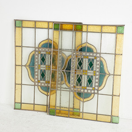 LEAD GLASS. A pair, yellow green colour scheme, circular facet cut ...