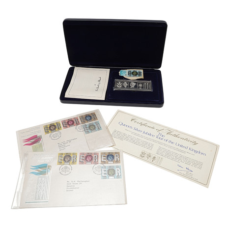 A CASED SILVER JUBILEE STAMP AND SILVER PRESENTATION SET. Silver ...