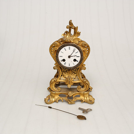 A bronze gilt brass table clock with key and pendulum, late 19th ...